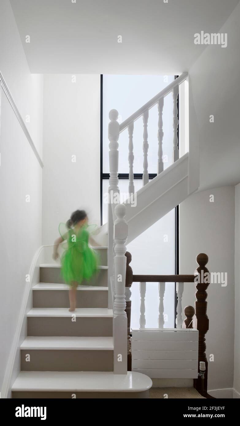Girl in green costume climbing staircase Stock Photo - Alamy