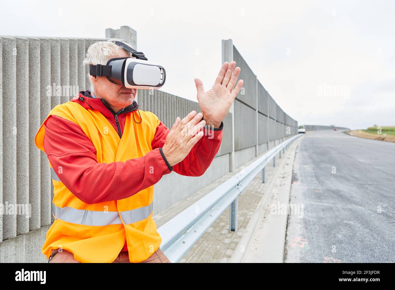 Architect on a road construction site uses VR glasses for virtual ...