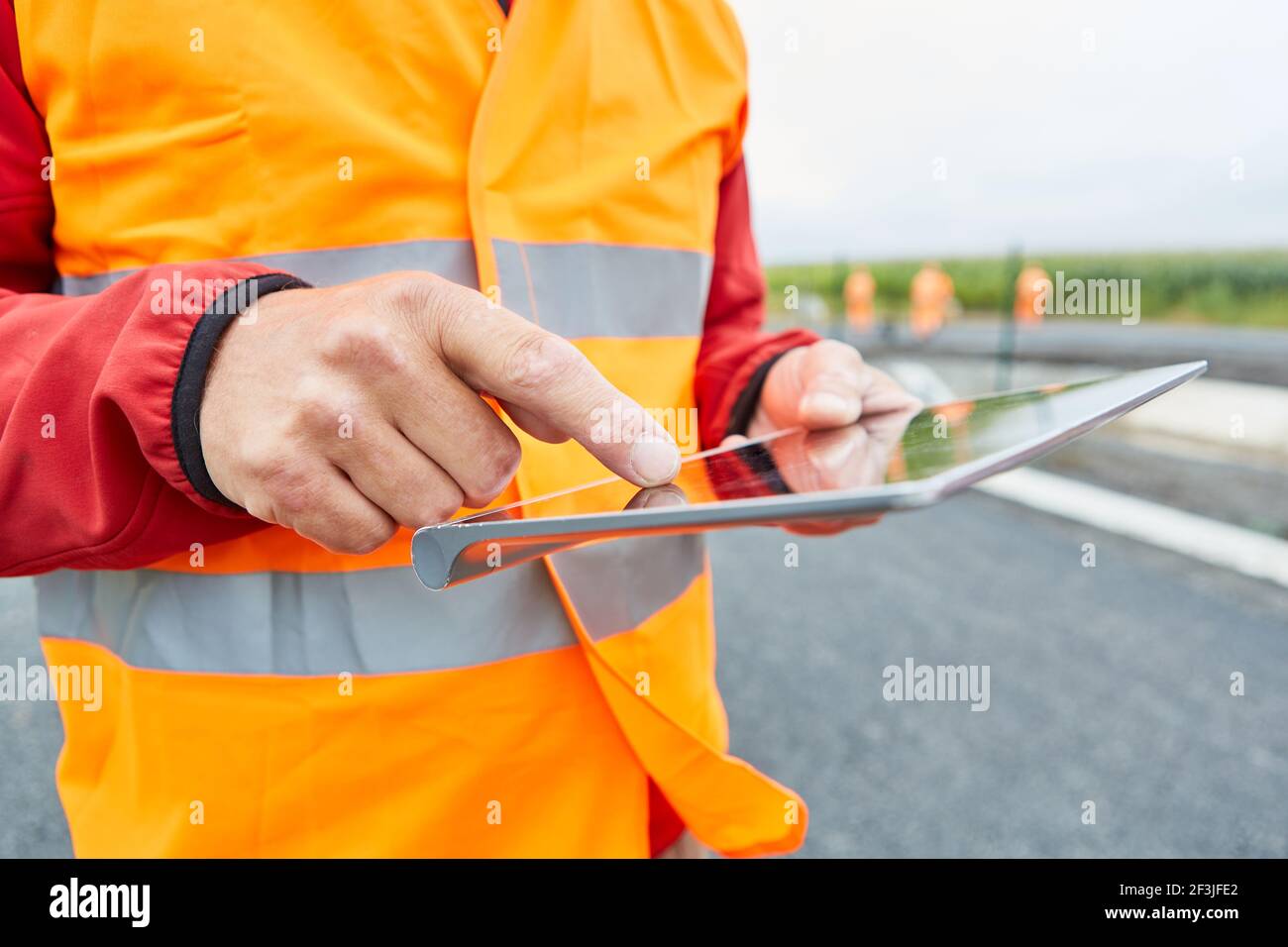 Construction worker using tablet computer during construction planning ...