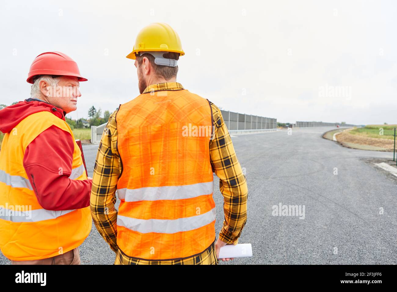 The architect and construction worker discuss upgrading or repairing ...