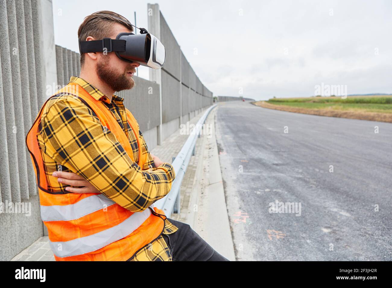 Construction workers with VR glasses on the construction site for ...