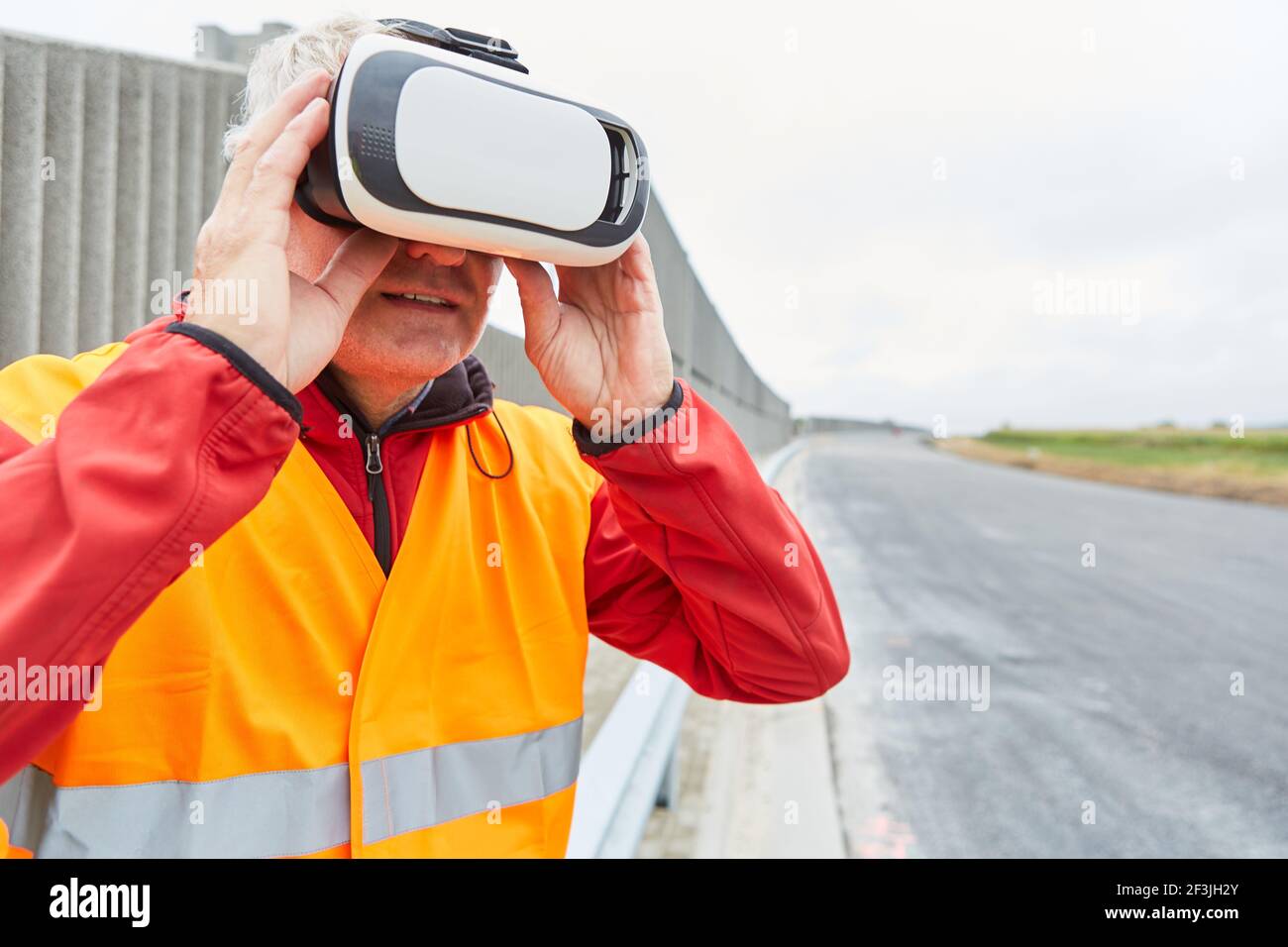 Construction workers with VR glasses on the construction site as a ...