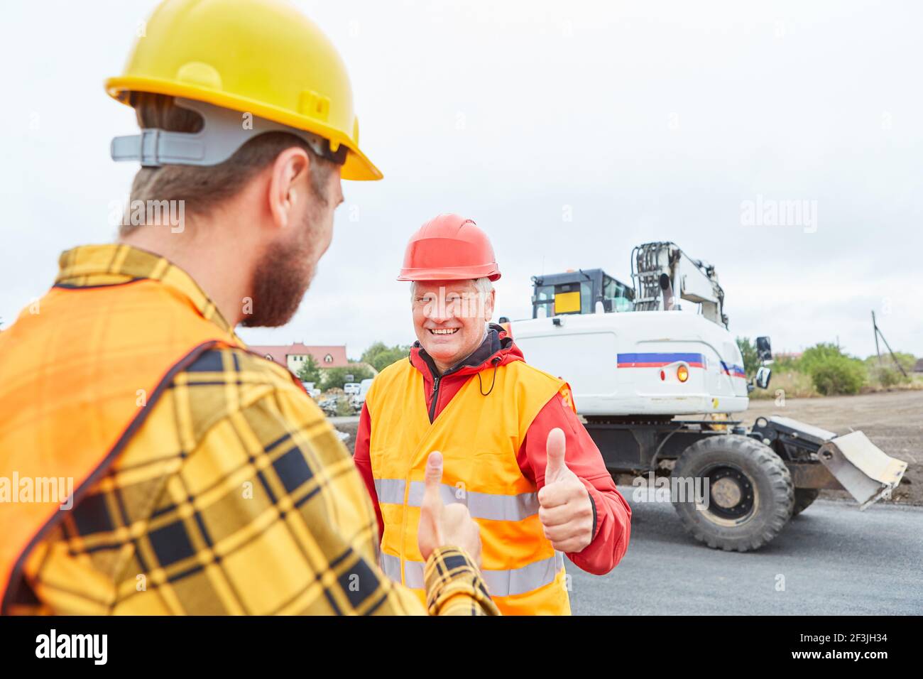 Architect and construction worker with thumbs up as motivation on ...