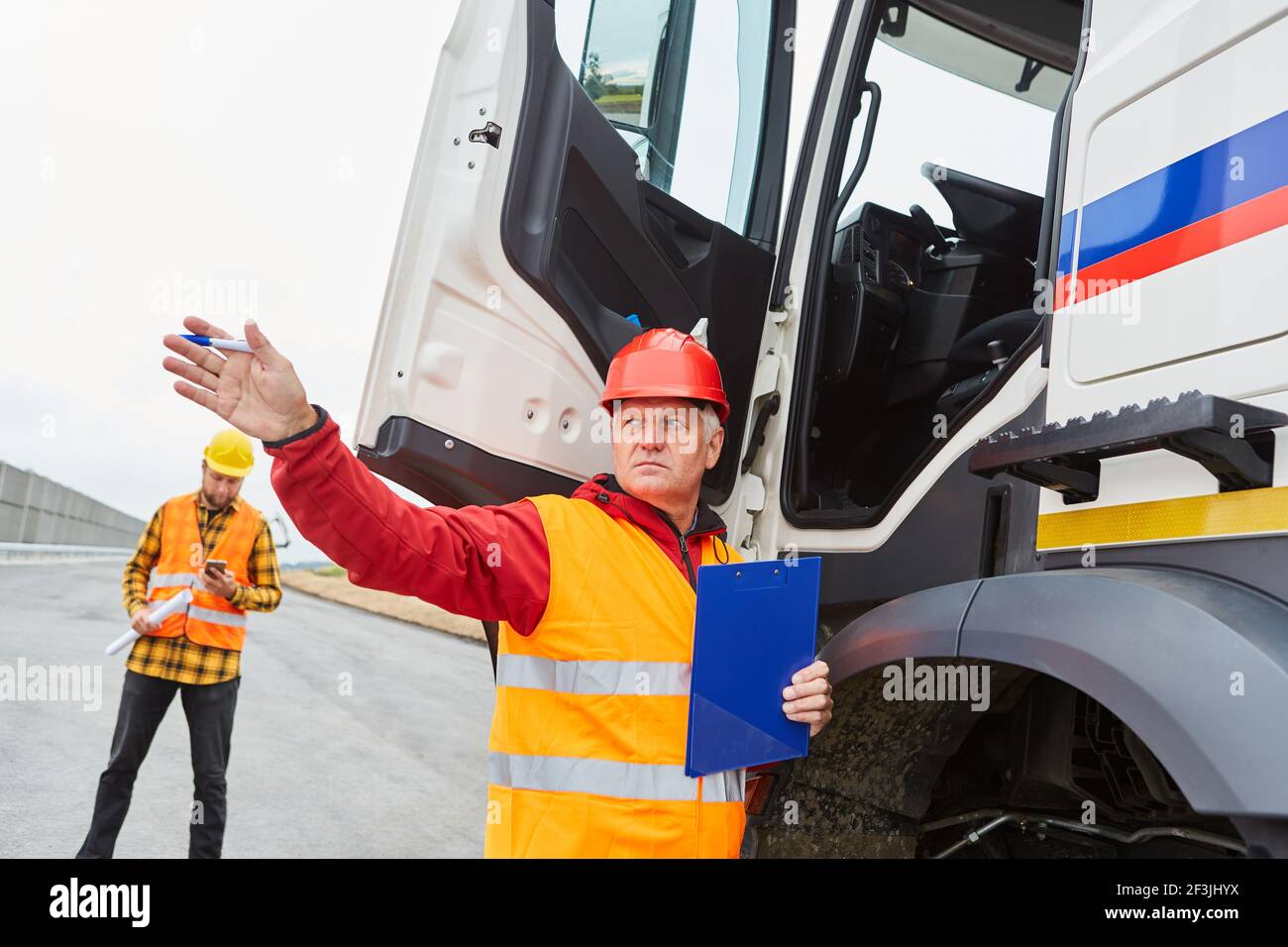 Construction manager on truck with checklist gives direction for ...