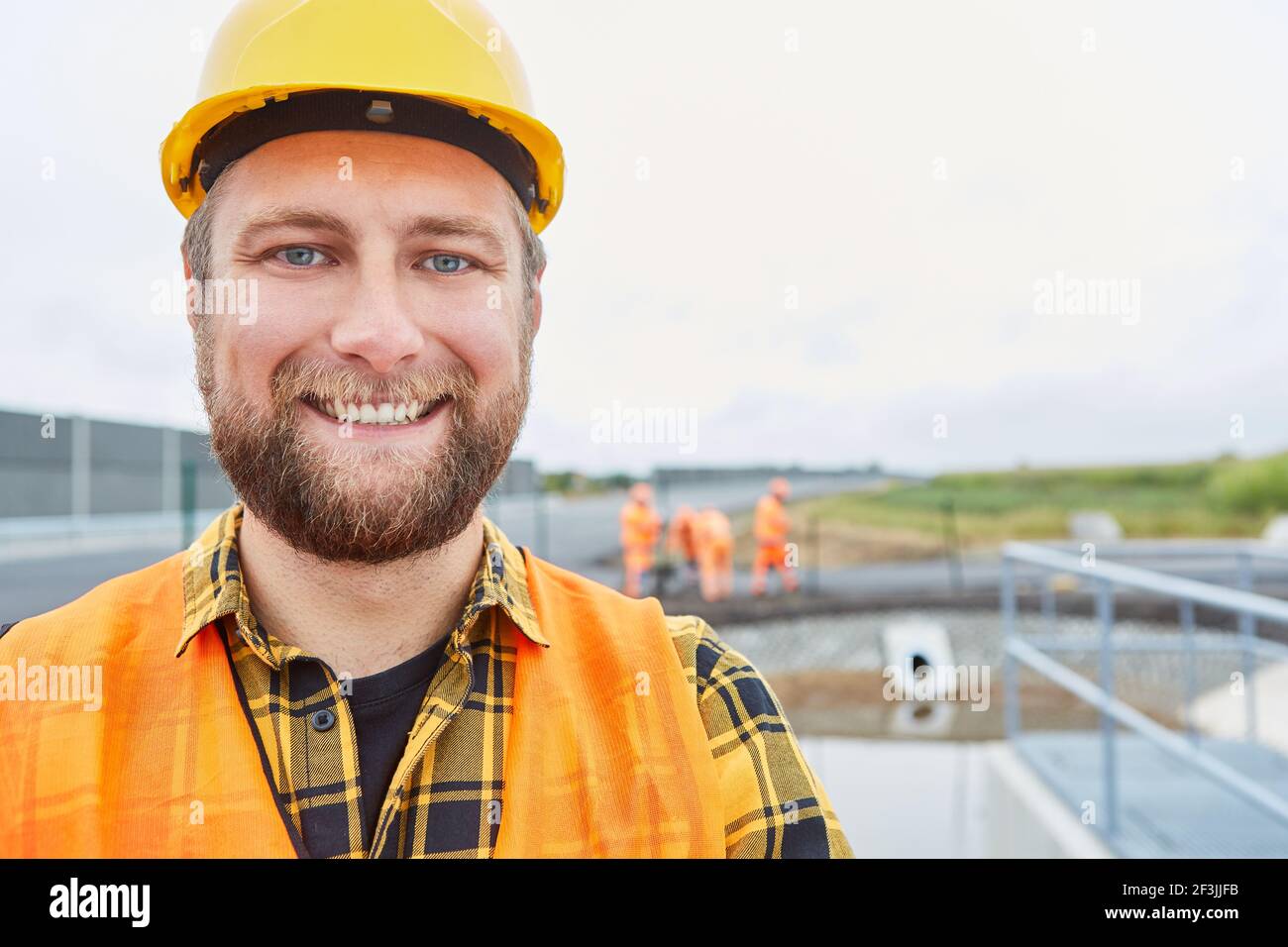 Smiling construction worker as a proud road builder on a construction ...