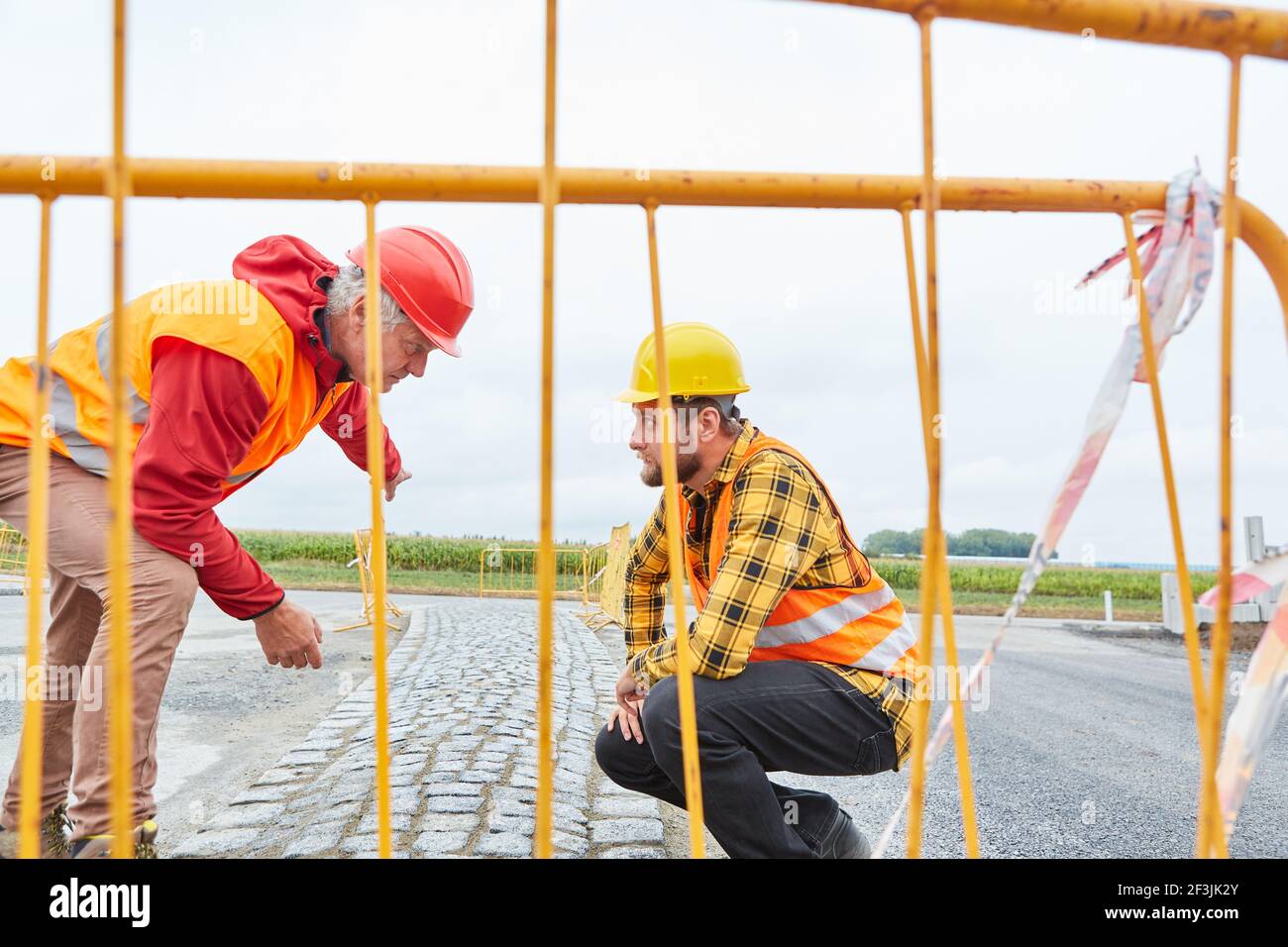 Construction workers on the construction site control the road surface ...