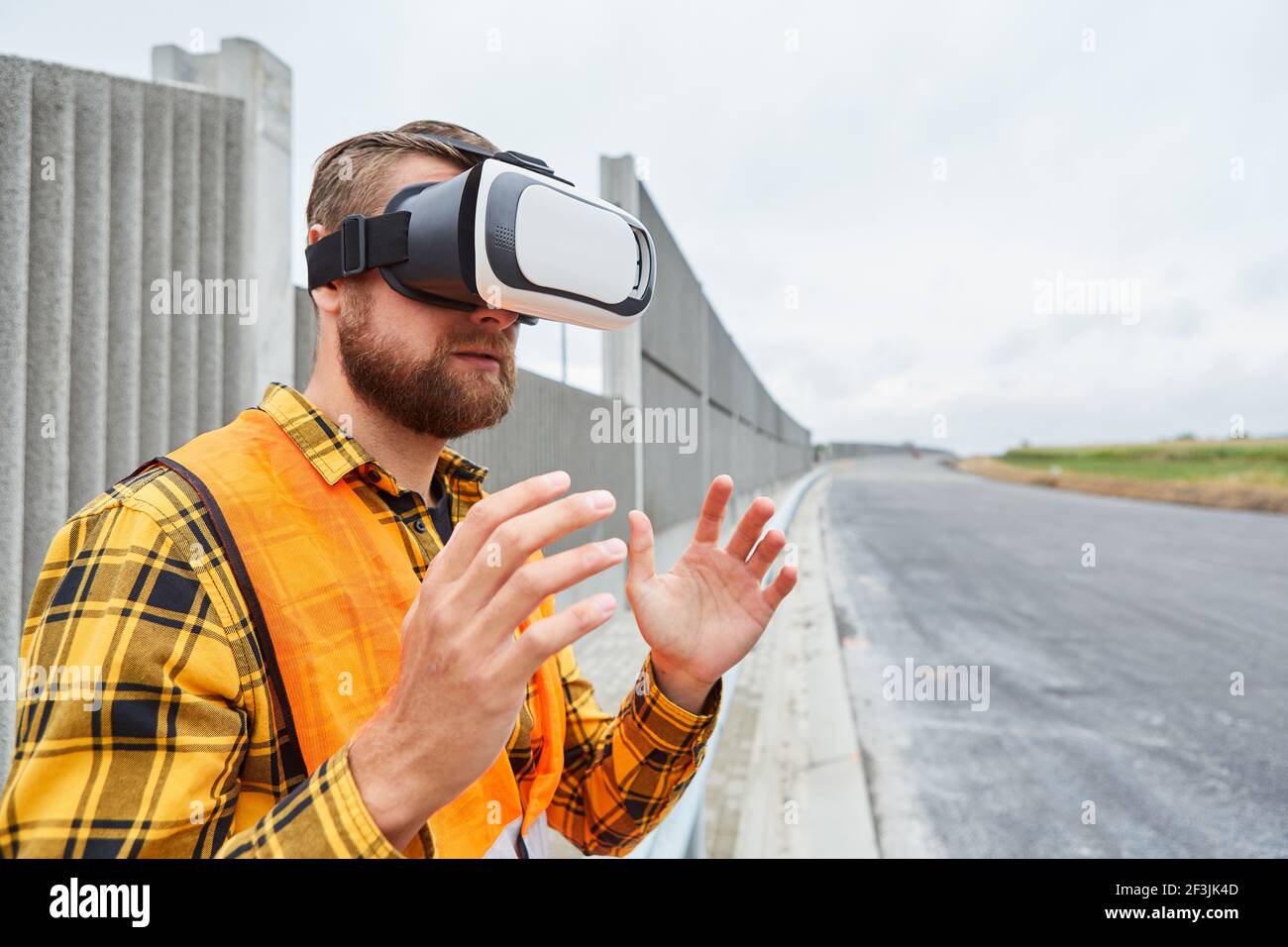 Worker with VR glasses during virtual construction planning on a ...