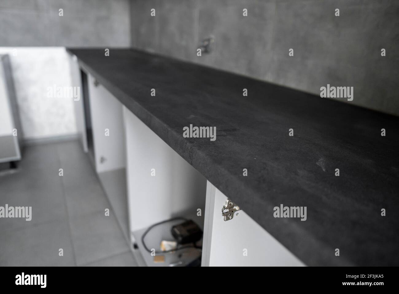 Dark gray countertop installed on a custom kitchen. Gray modular ...