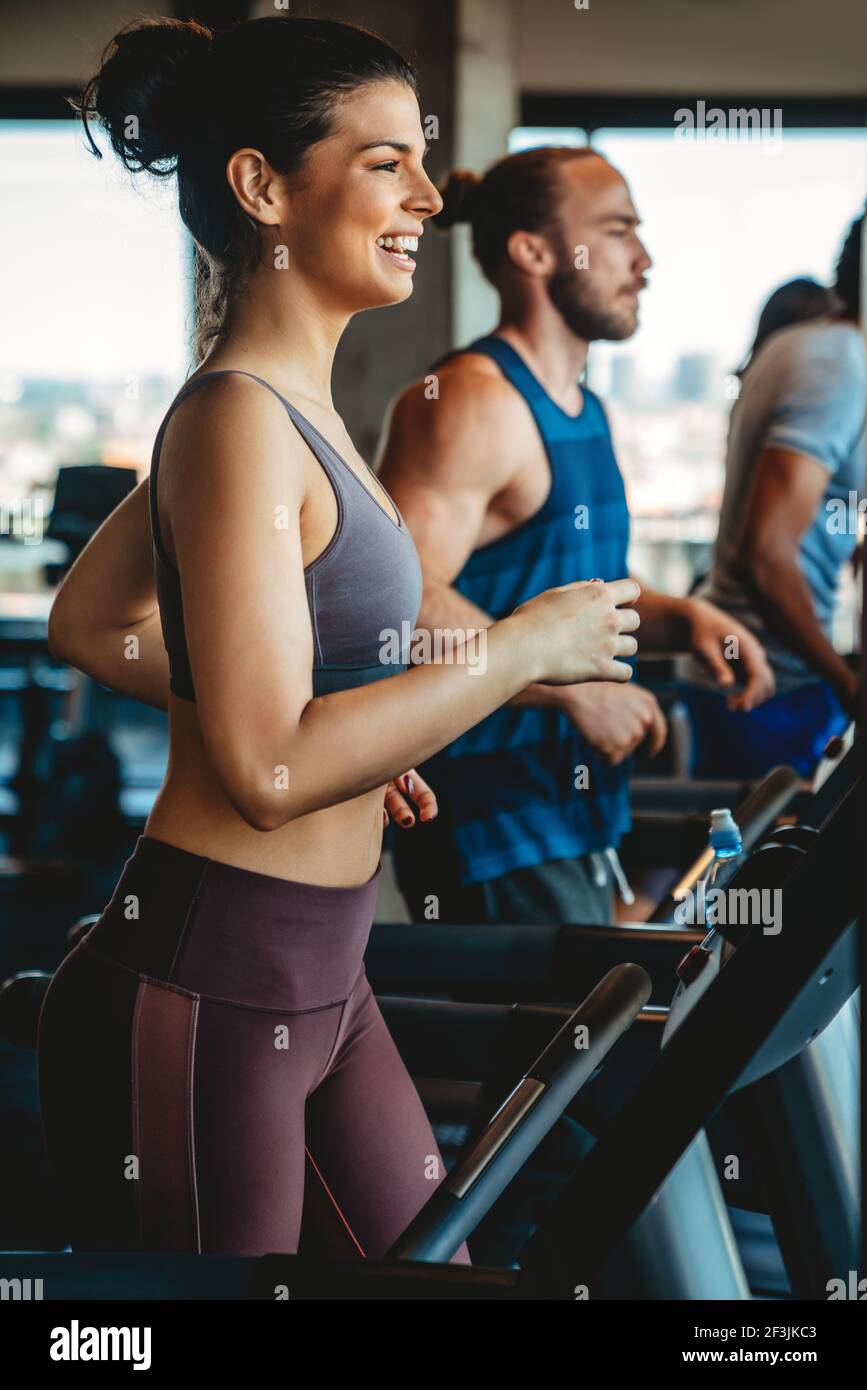Group of young people running on treadmills in sport gym Stock Photo ...