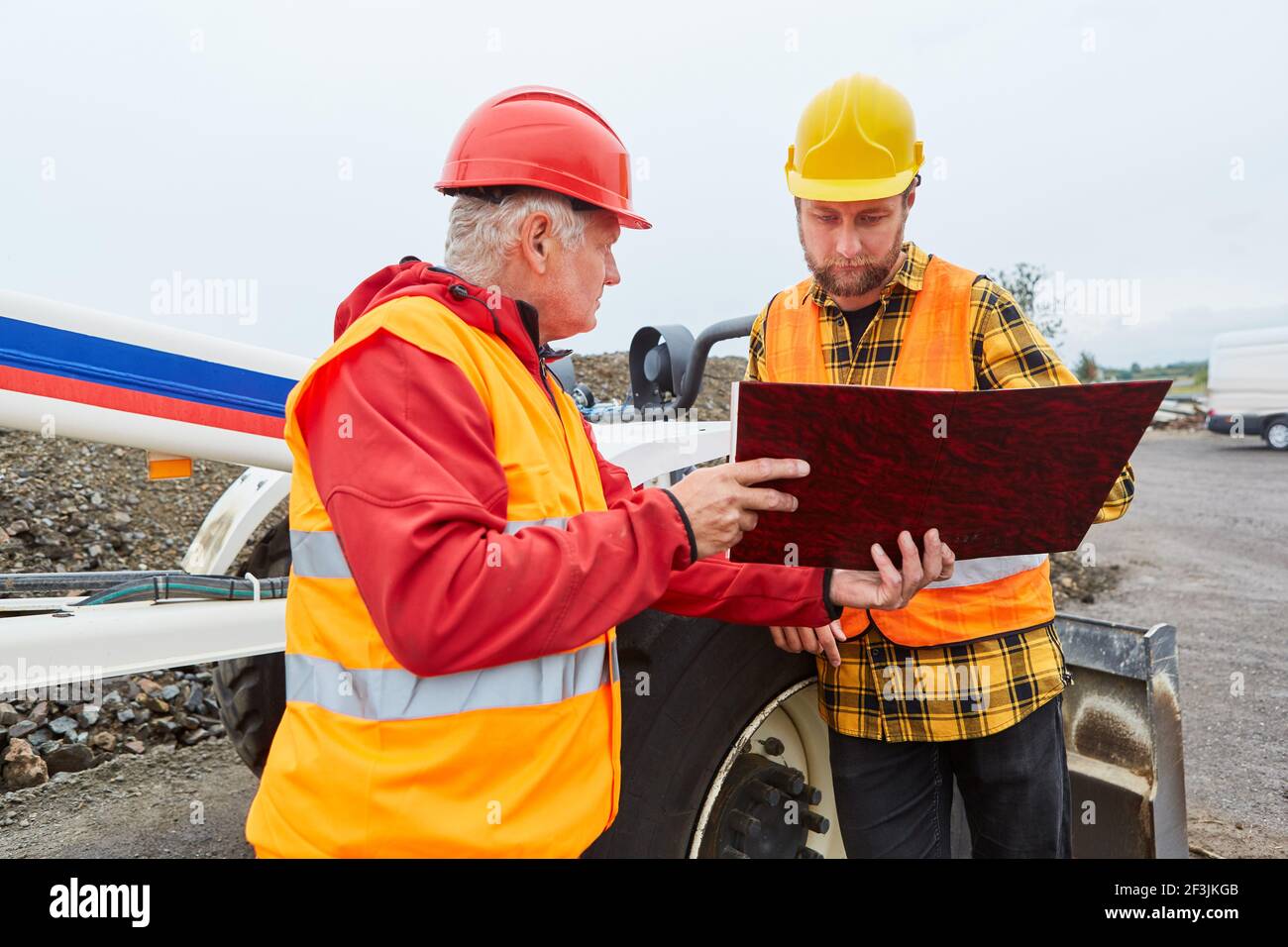 Architect and construction worker with documents on the construction ...