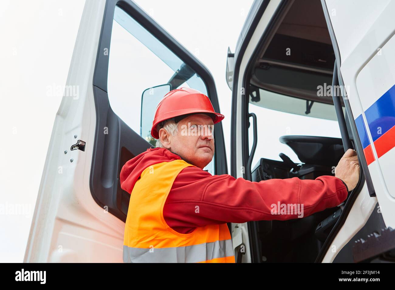 Construction workers or truck drivers in front of the cab on the road ...