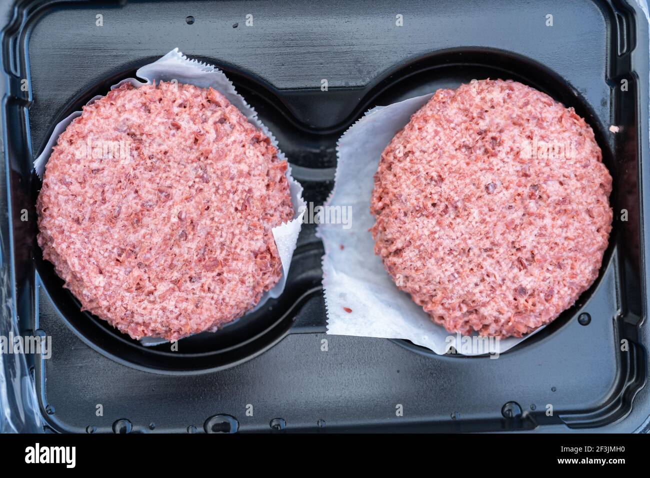 Vegetarian burger patties in plastic container Stock Photo - Alamy