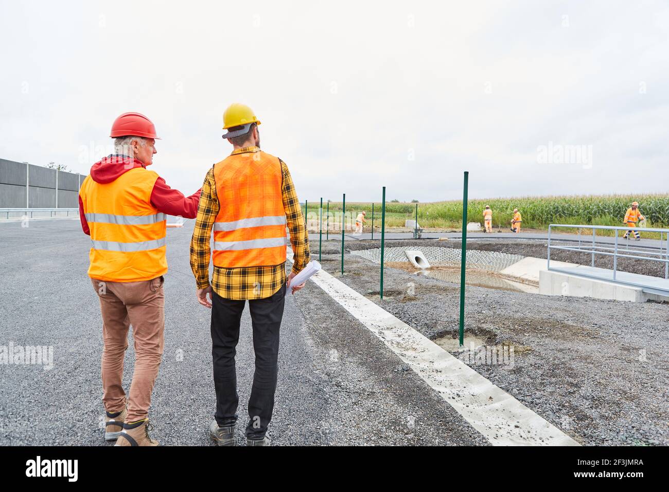 Architect and site manager inspecting a road construction site in the ...