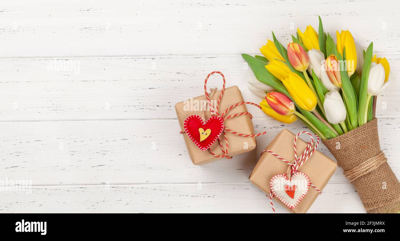 Colorful tulip flowers bouquet and gift boxes with heart shaped decor ...