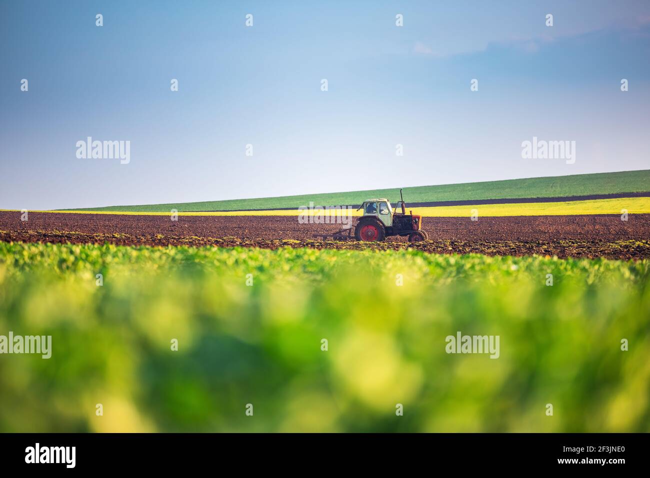 Tractor plowing the fields , agricultural landscape Stock Photo - Alamy