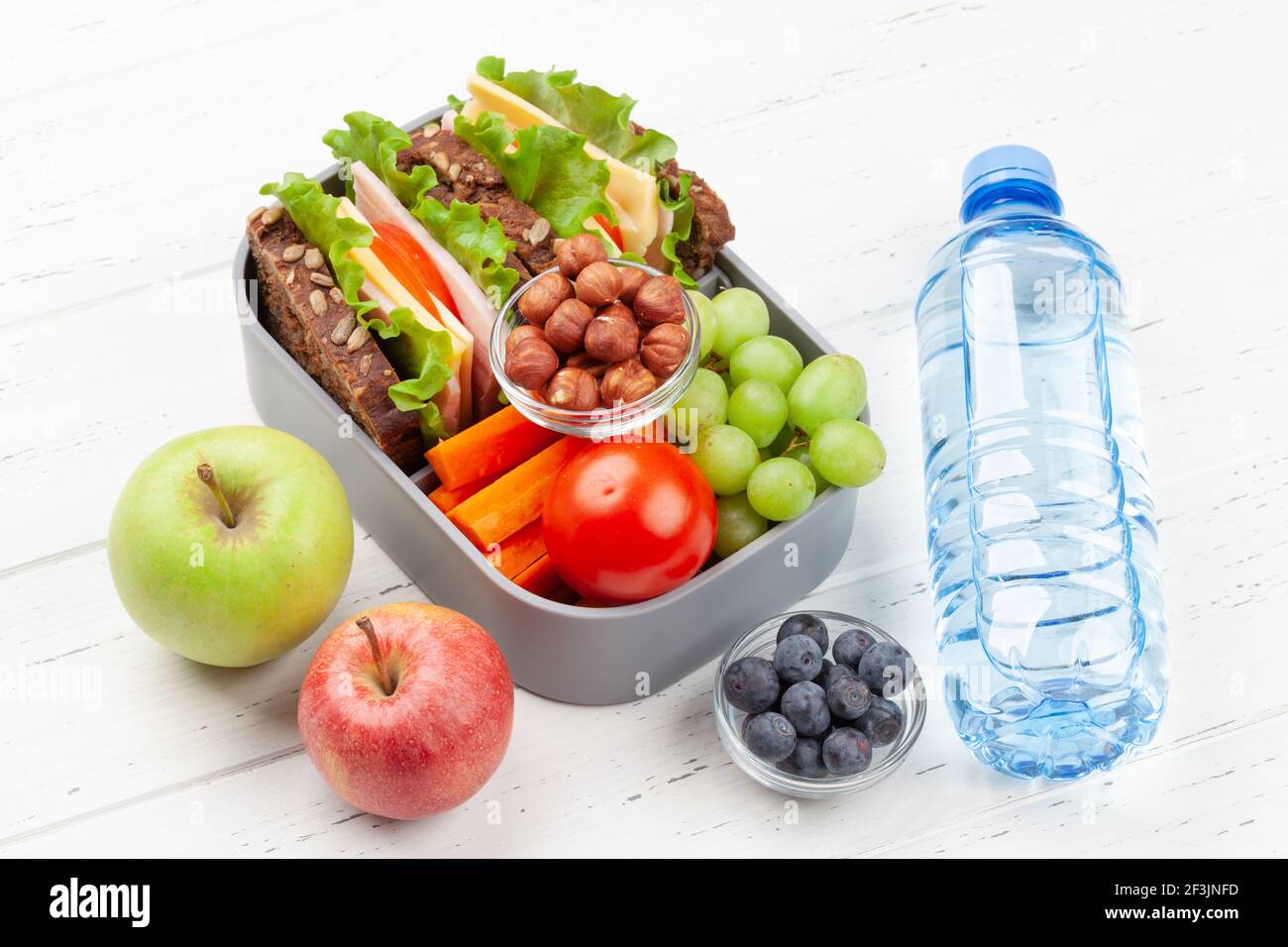 Healthy school lunch box with sandwich and fresh vegetables, water ...