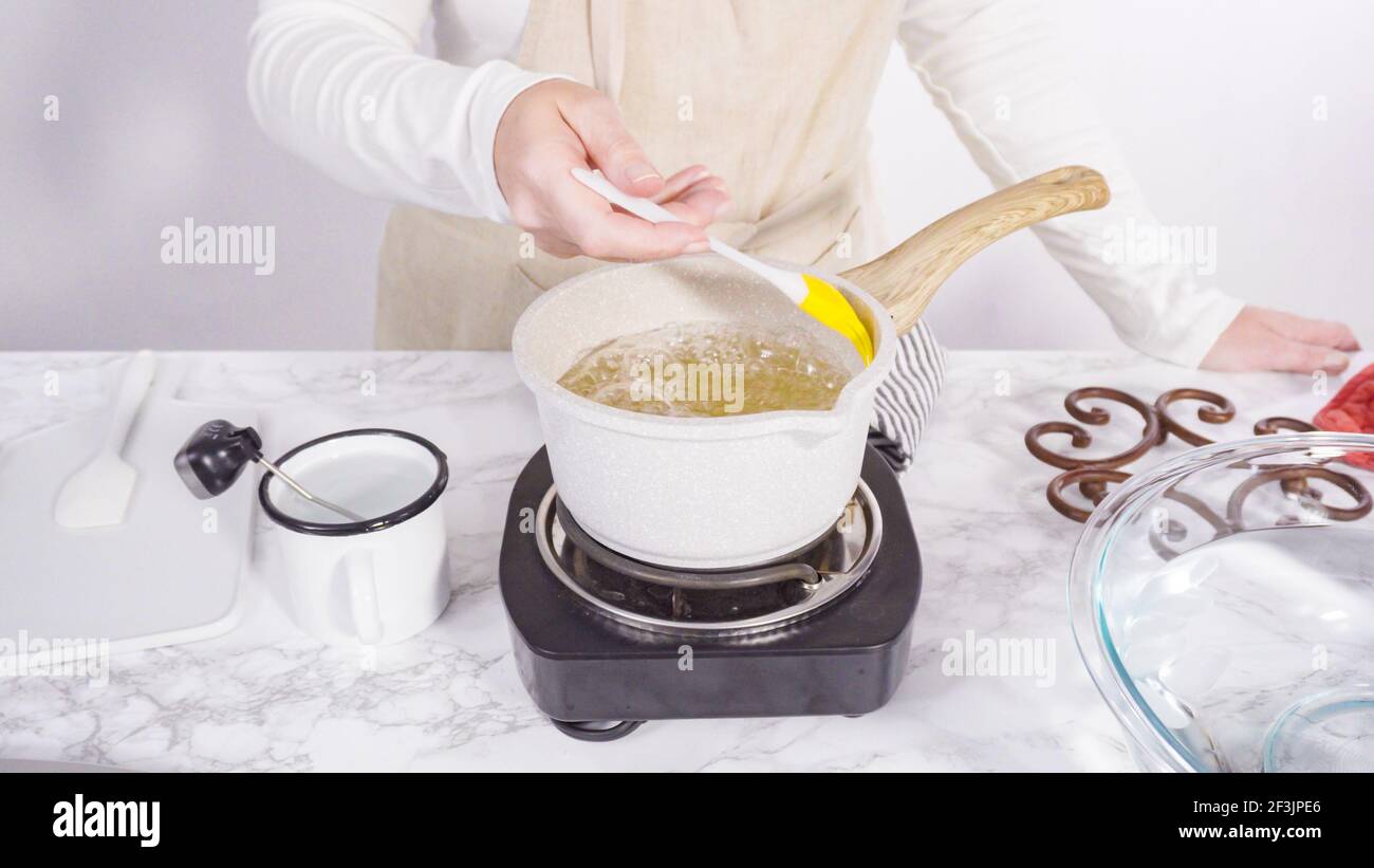 Step by step. Caramelizing sugar in a small cooking pot over the small ...
