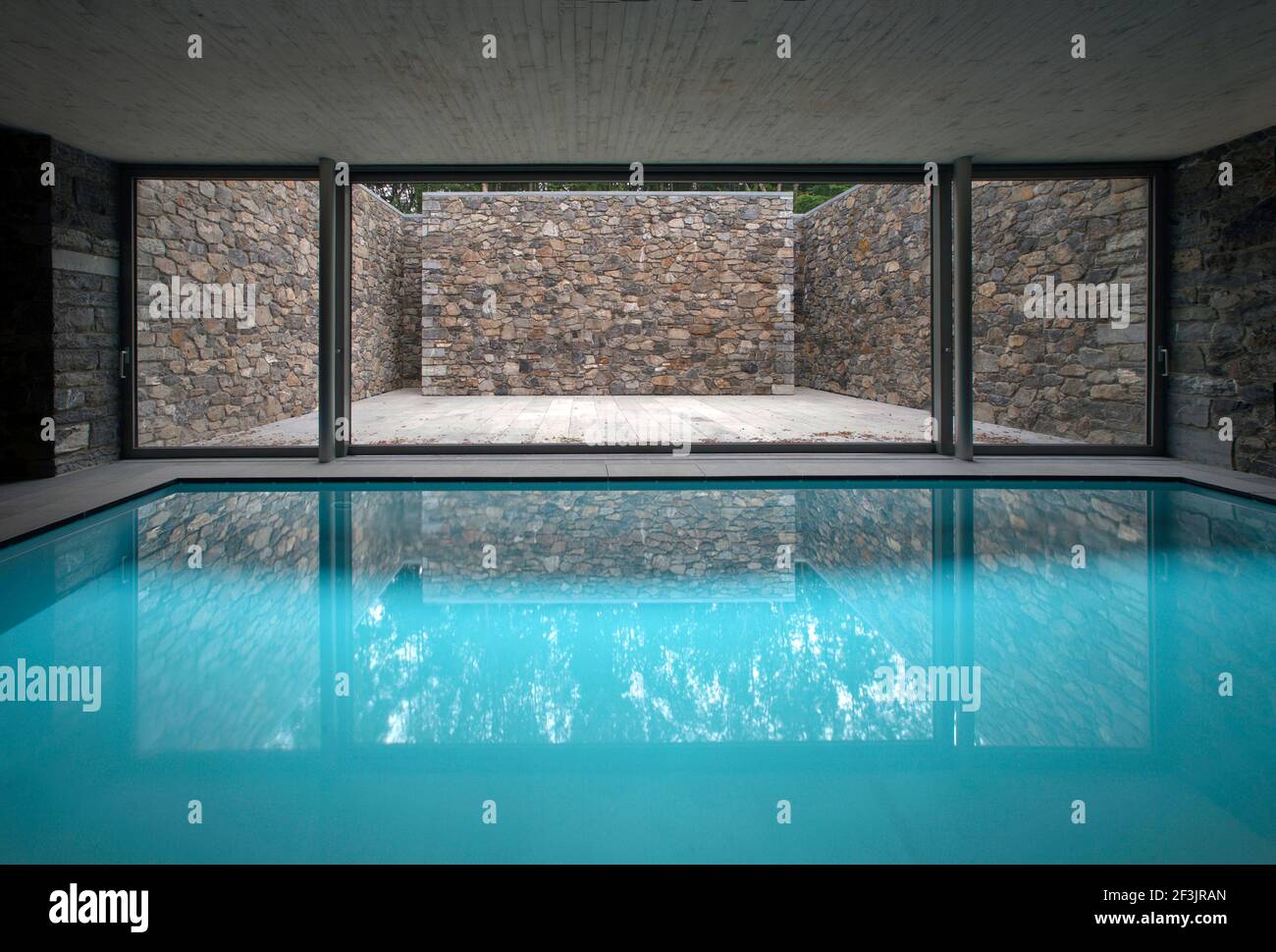 Swimming pool with view out to empty patio area Stock Photo - Alamy