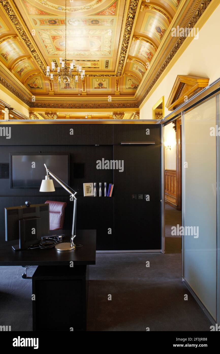 Cellular office with black ash joinery under ornate baroque ceiling ...