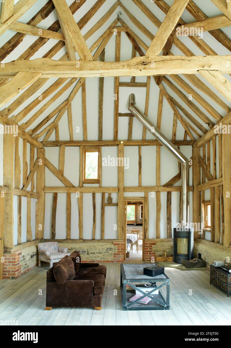 Living room in barn conversion with exposed beams, Field Place Barns ...