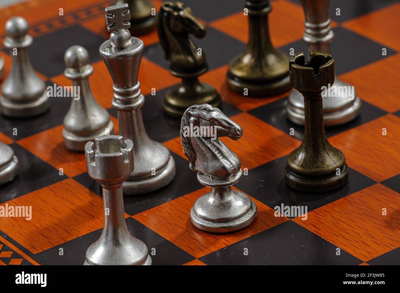 Wooden chess board with metal pieces. Checkmate Stock Photo - Alamy
