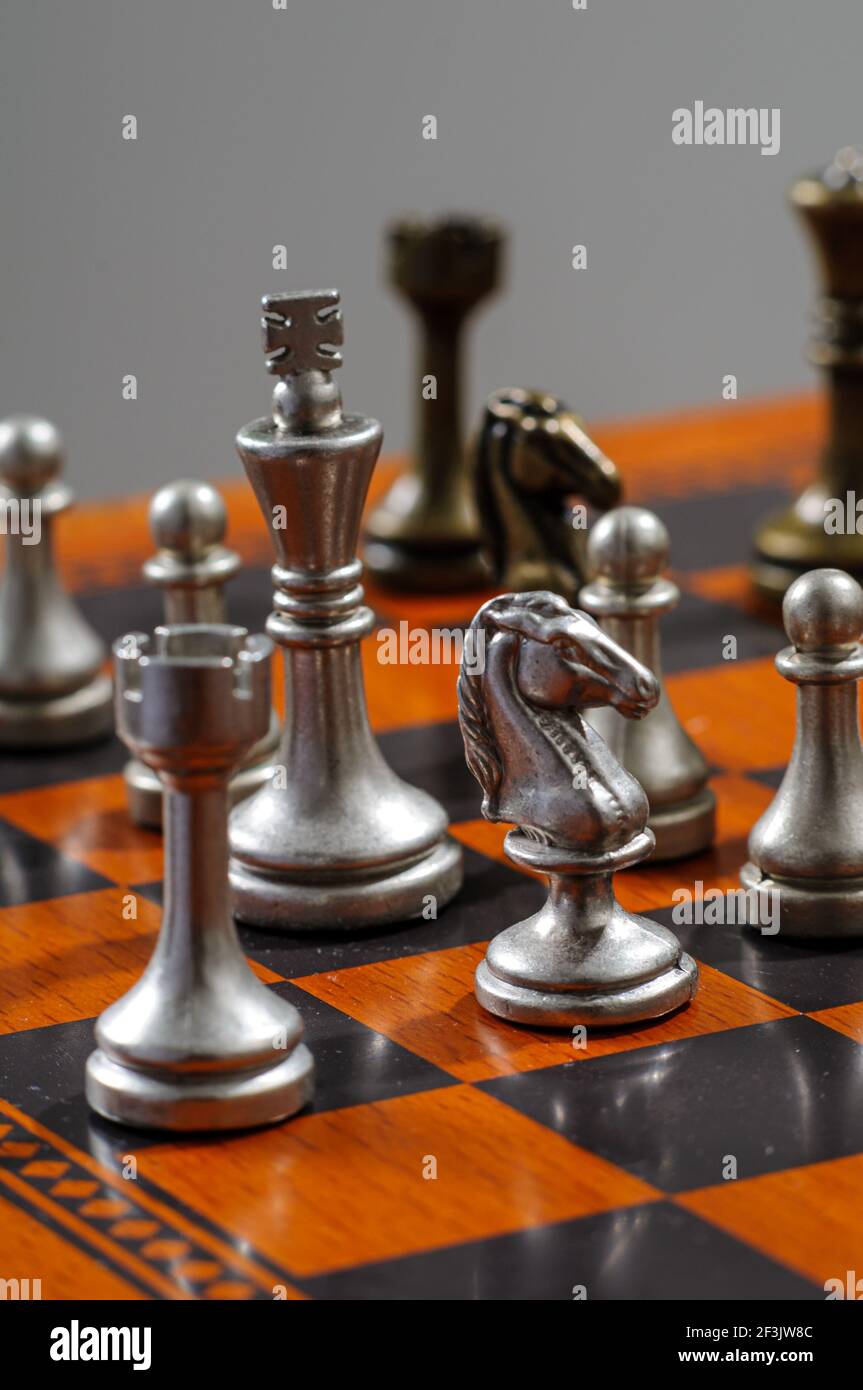 Wooden chess board with metal pieces. Checkmate Stock Photo - Alamy
