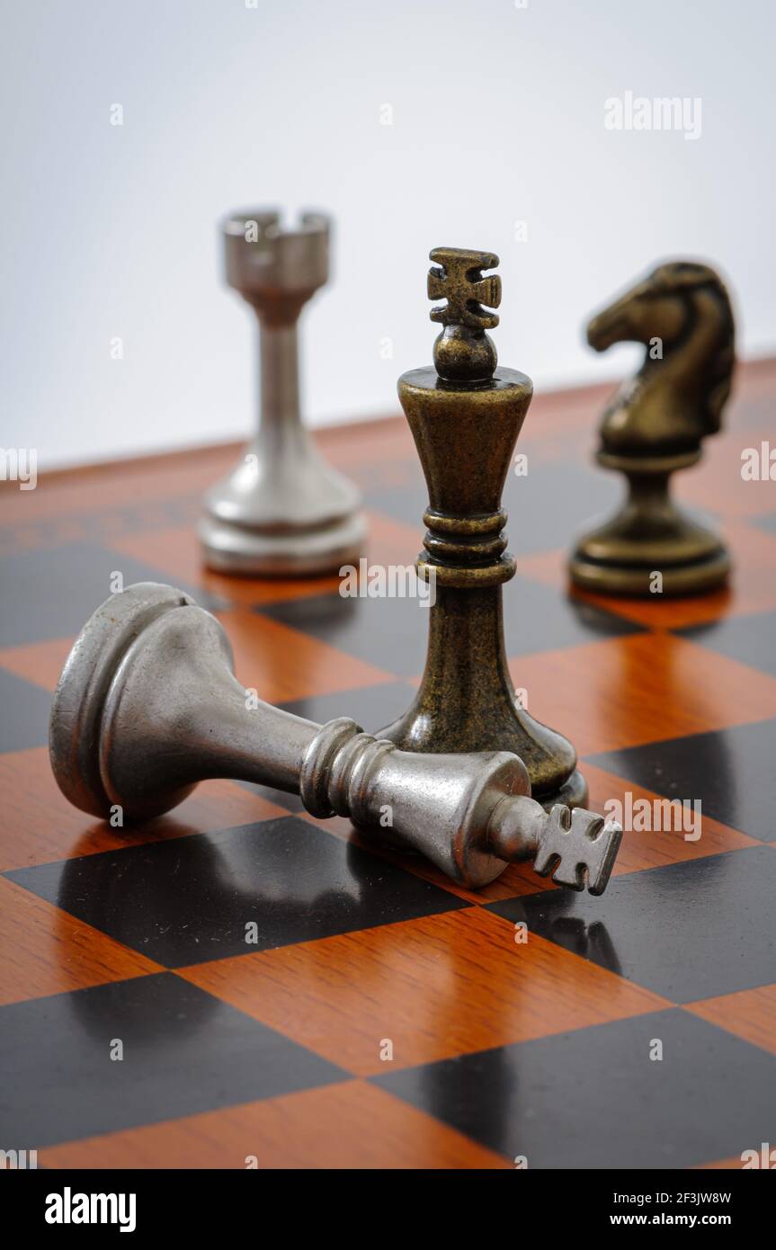 Wooden chess board with metal pieces. Checkmate Stock Photo - Alamy
