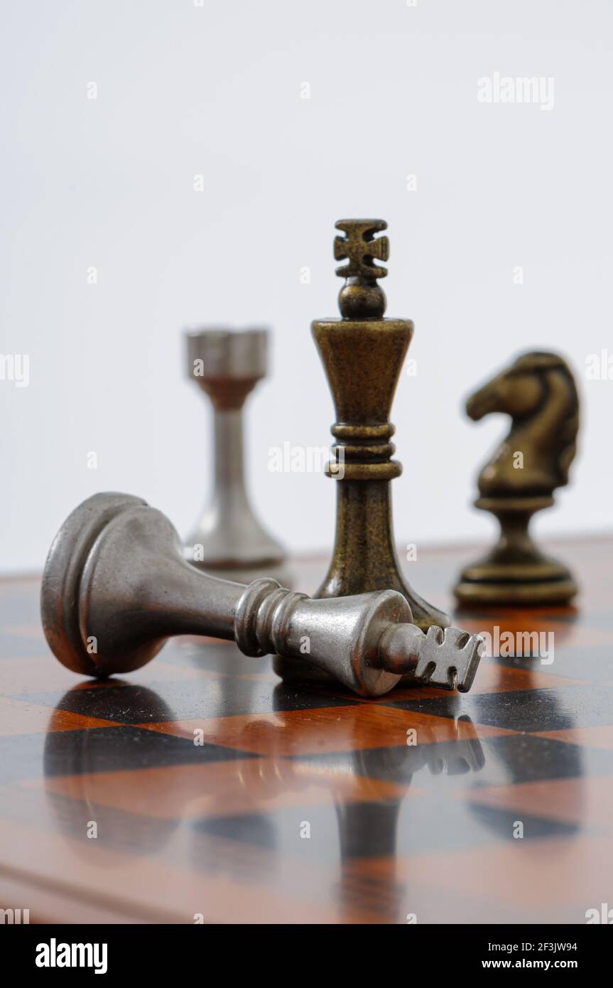 Wooden chess board with metal pieces. Checkmate Stock Photo - Alamy