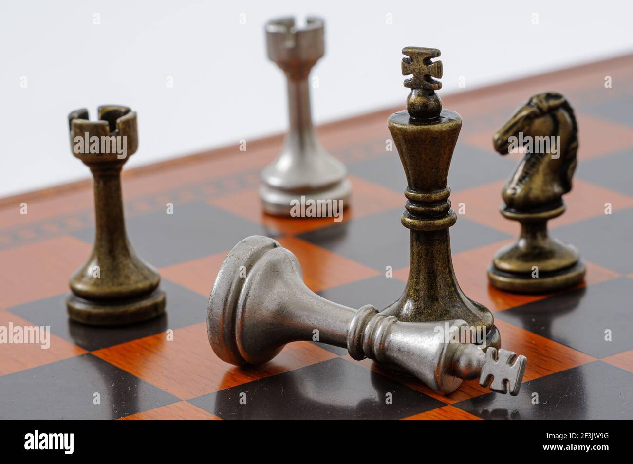 Wooden chess board with metal pieces. Checkmate Stock Photo - Alamy