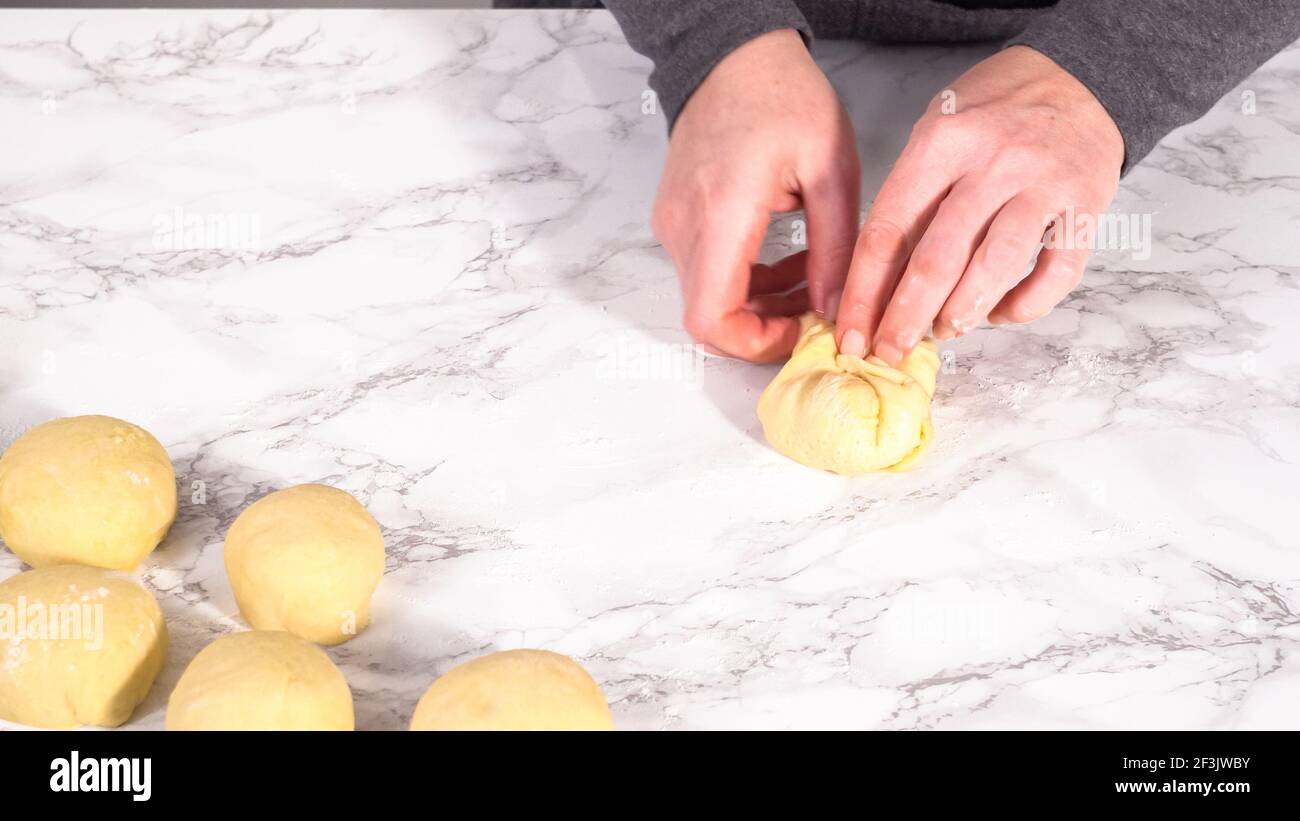 Step by step. Dividing bread dough to bake homemade brioche buns Stock ...