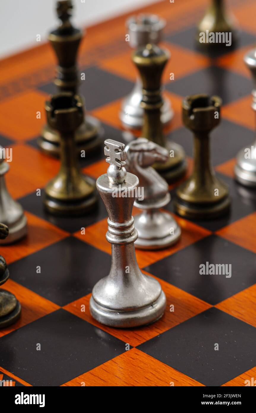 Wooden chess board with metal pieces. Checkmate Stock Photo - Alamy