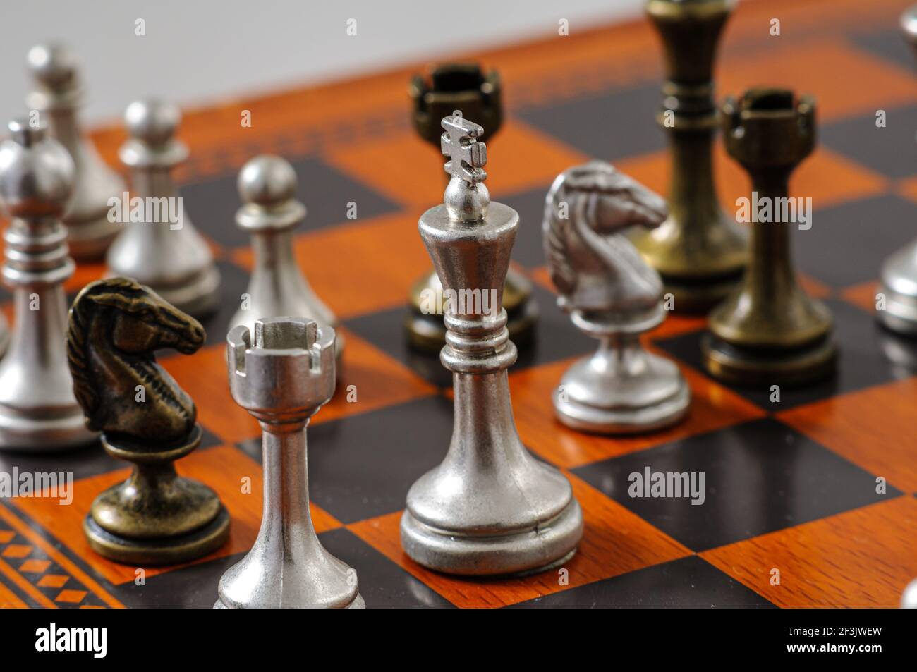 Wooden chess board with metal pieces. Checkmate Stock Photo - Alamy