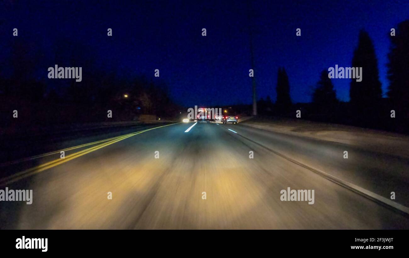Driving on typical paved roads at night in suburban America Stock Photo ...