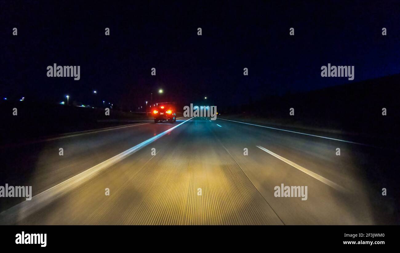 Driving on typical paved roads at night in suburban America Stock Photo ...