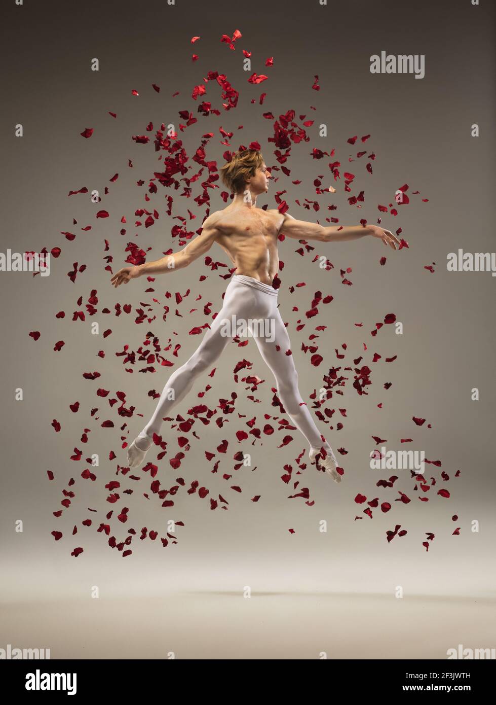 Heart. Young and graceful ballet dancer on studio background in flight ...