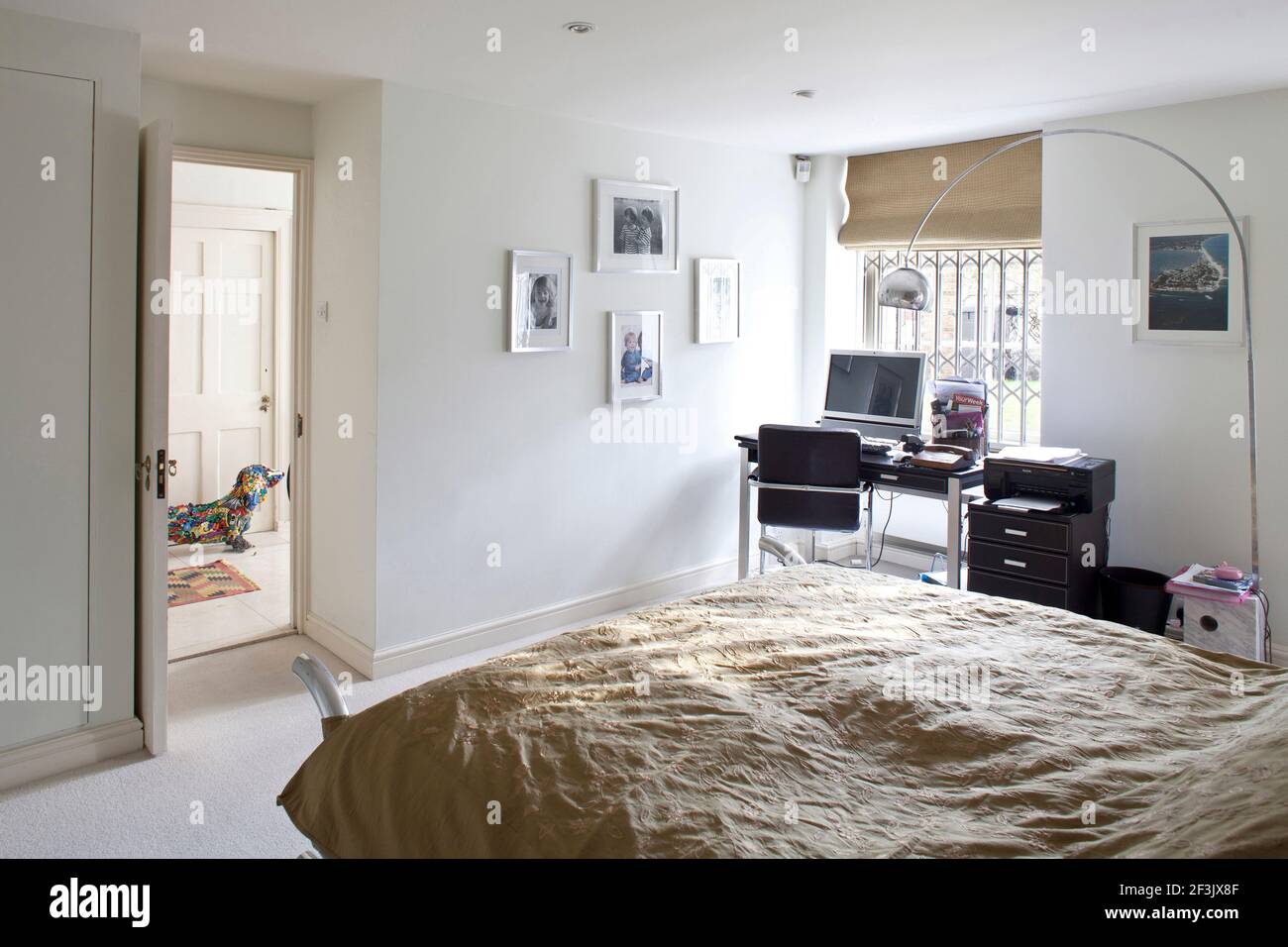 Double bed in modern bedroom with computer on table in corner, London ...