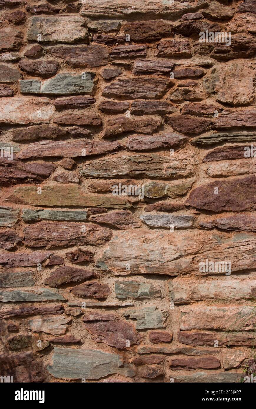 Red stone wall of a house in Hope Cove, Devon, UK Stock Photo - Alamy