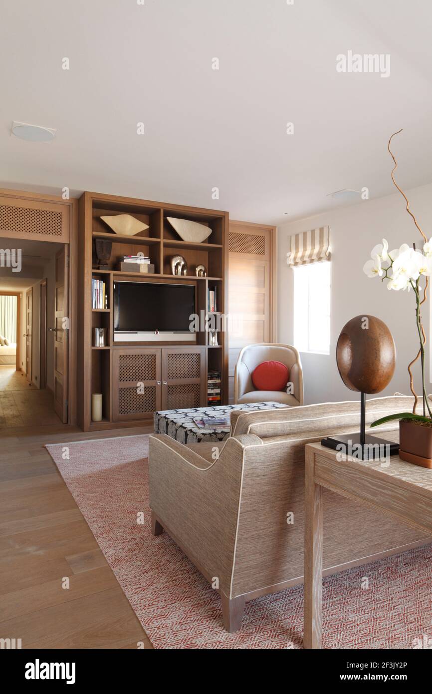 Study/TV room with flatscreen TV set into bespoke joinery. View along ...