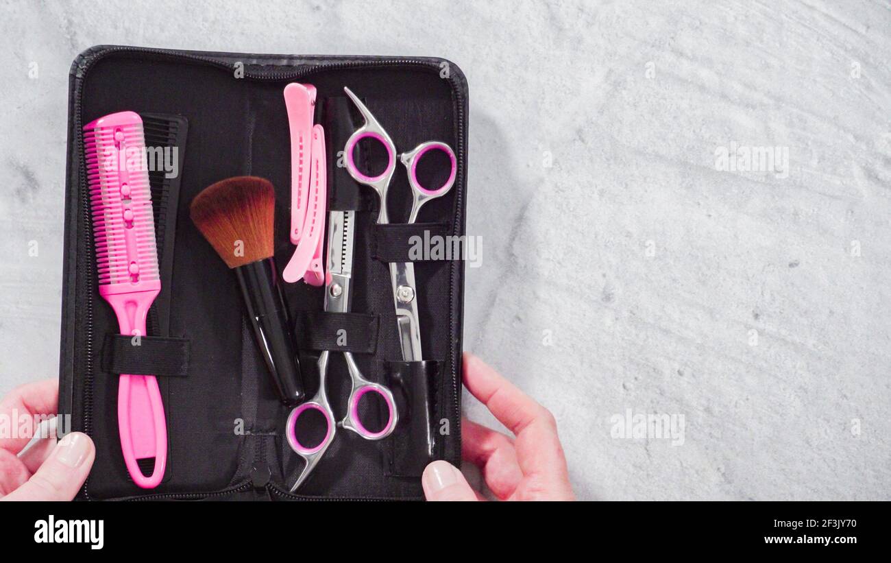 Flat lay. Pink hair cutting scissors set Stock Photo - Alamy
