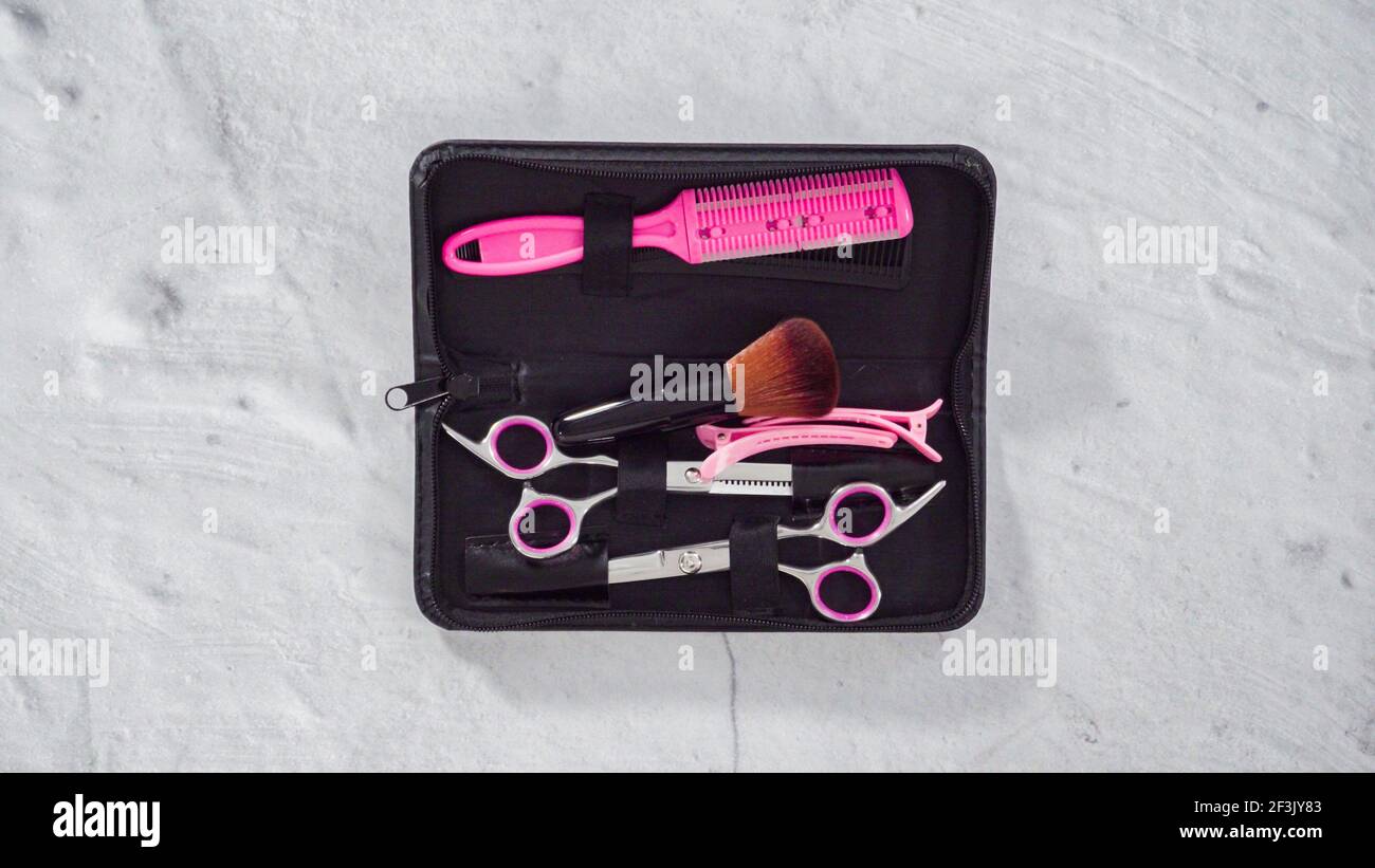 Flat lay. Pink hair cutting scissors set Stock Photo - Alamy