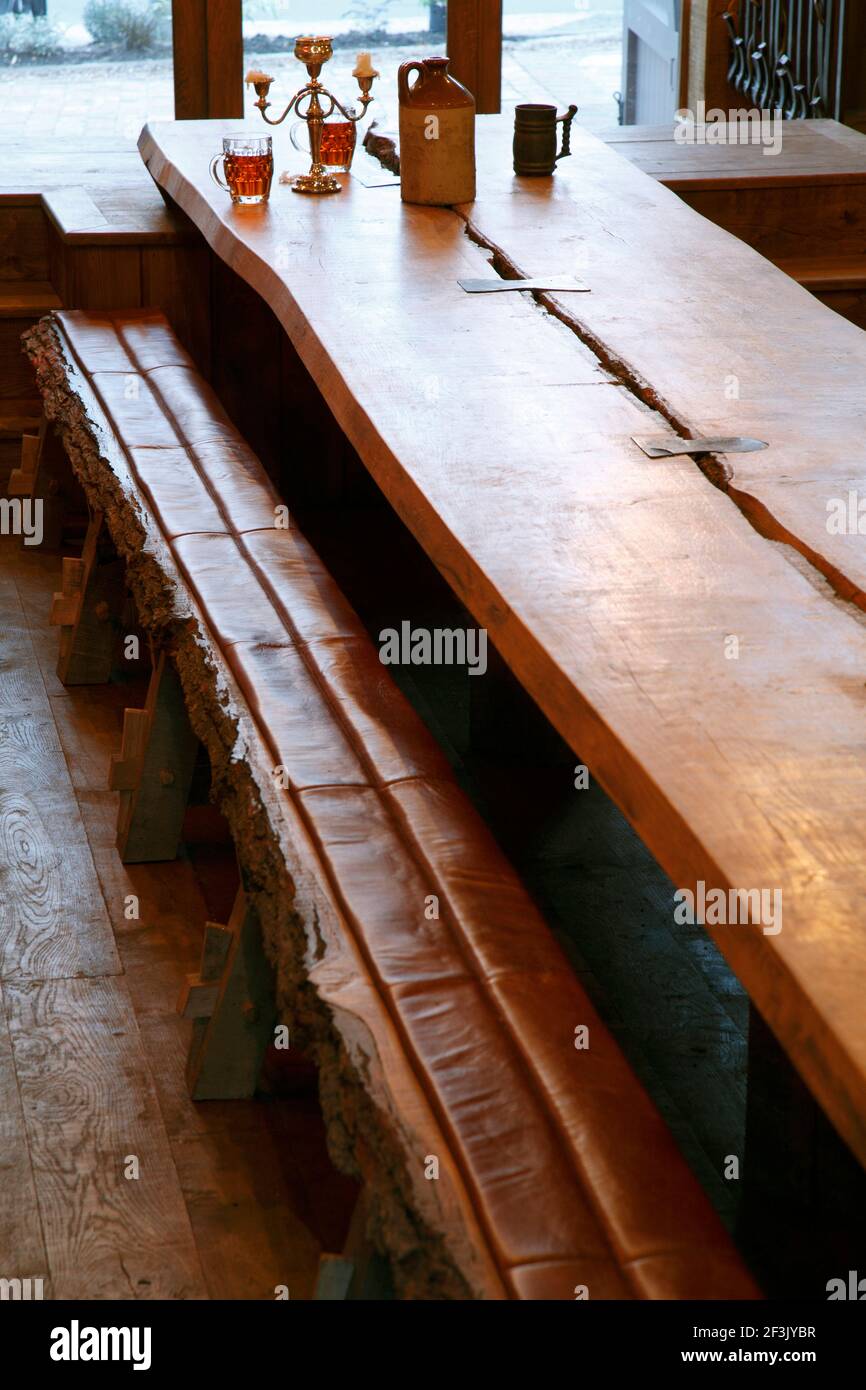 Long communal table and bench in old stables function room | | Designer ...