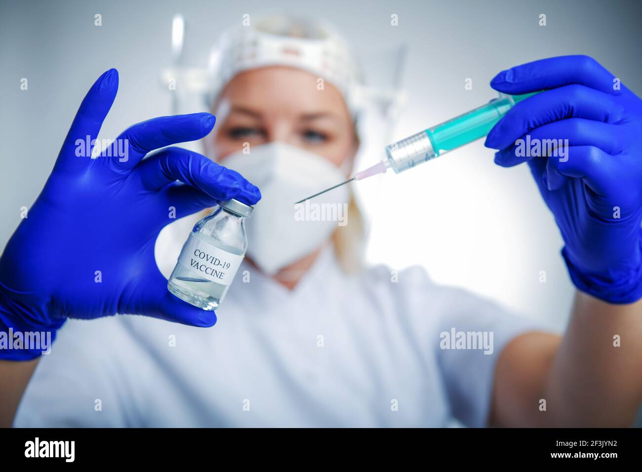 Detail closeup of syringe needle and ampoule , nurse taking injection ...