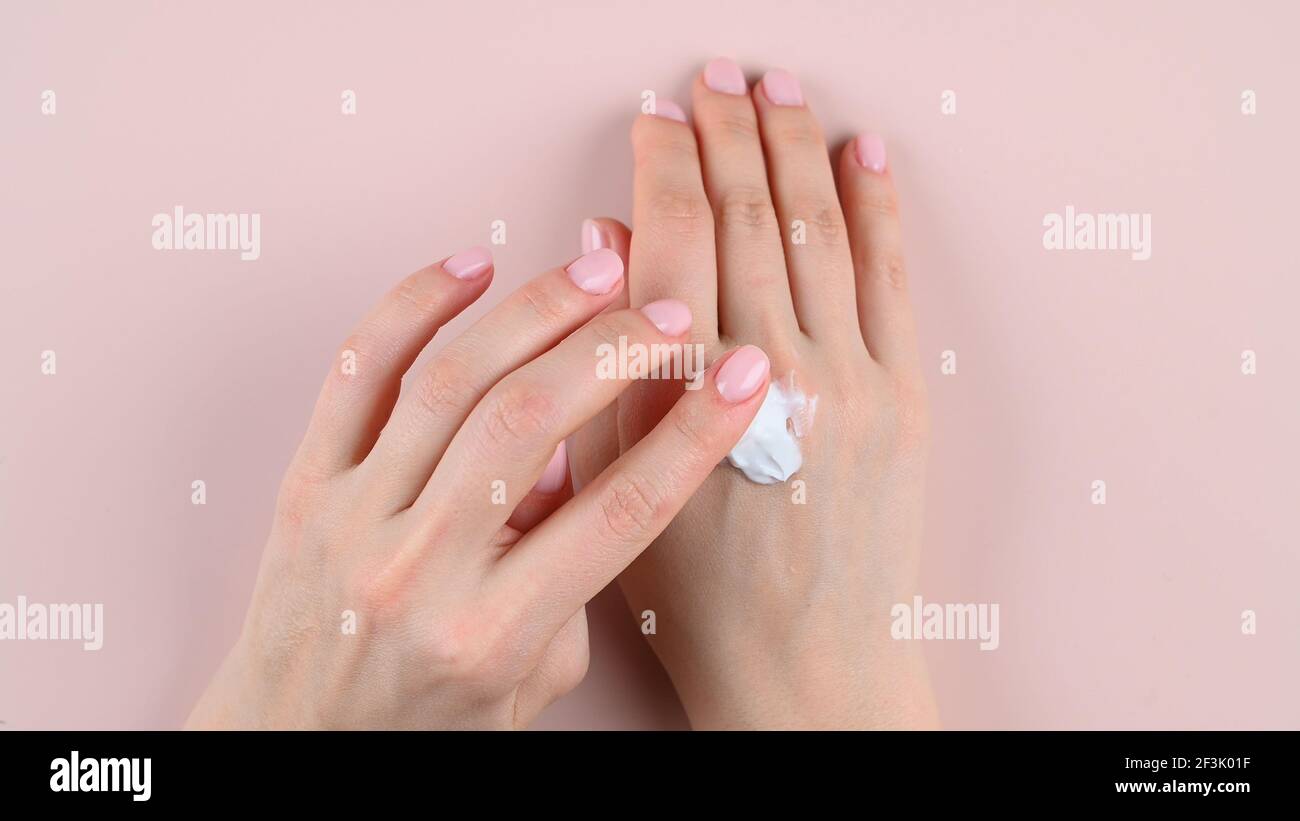 Girl smears hand cream, top view. High quality photo Stock Photo - Alamy