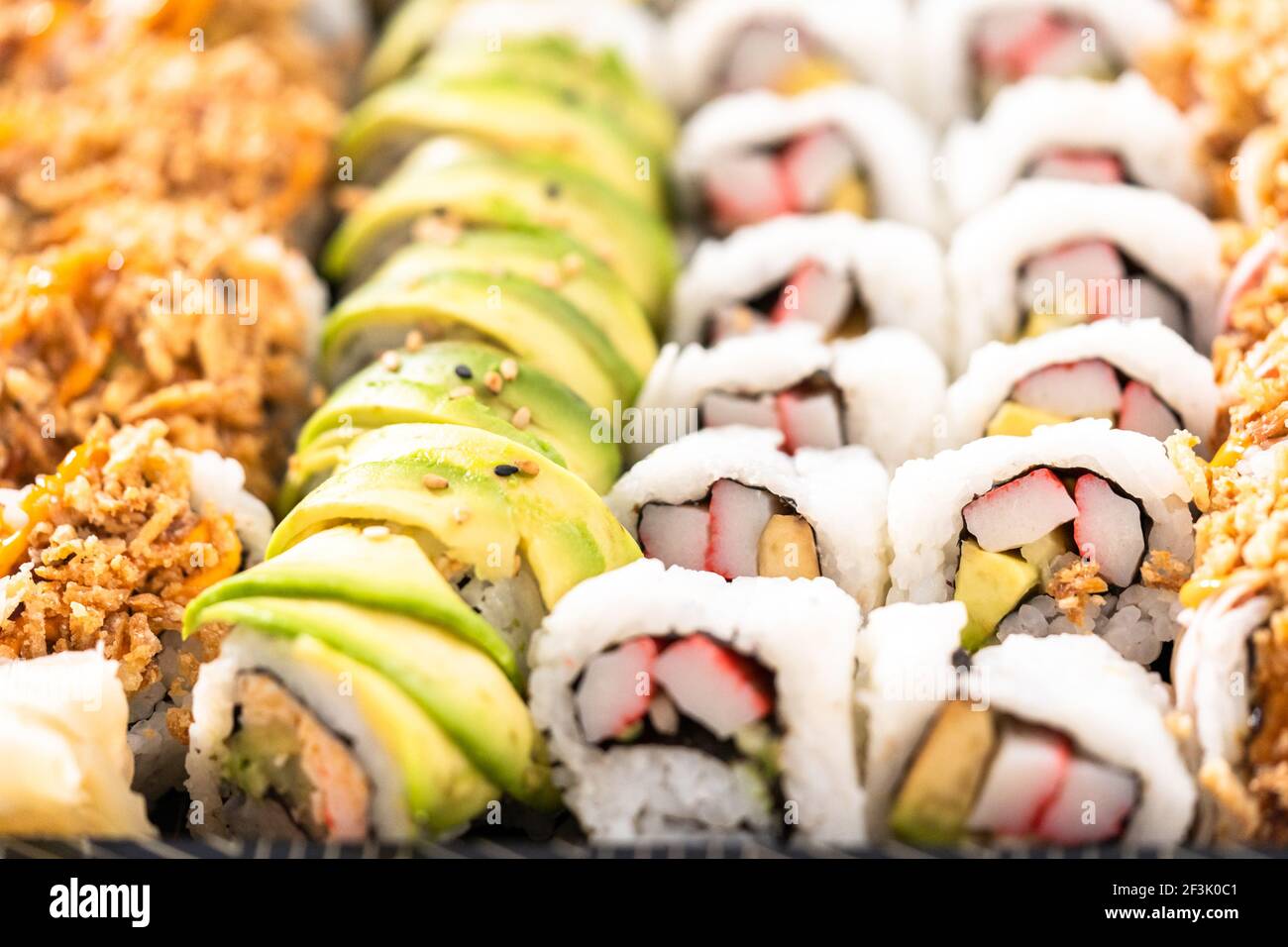 Pre-packaged variety of sushi and sushi rolls in a plastic tray Stock ...