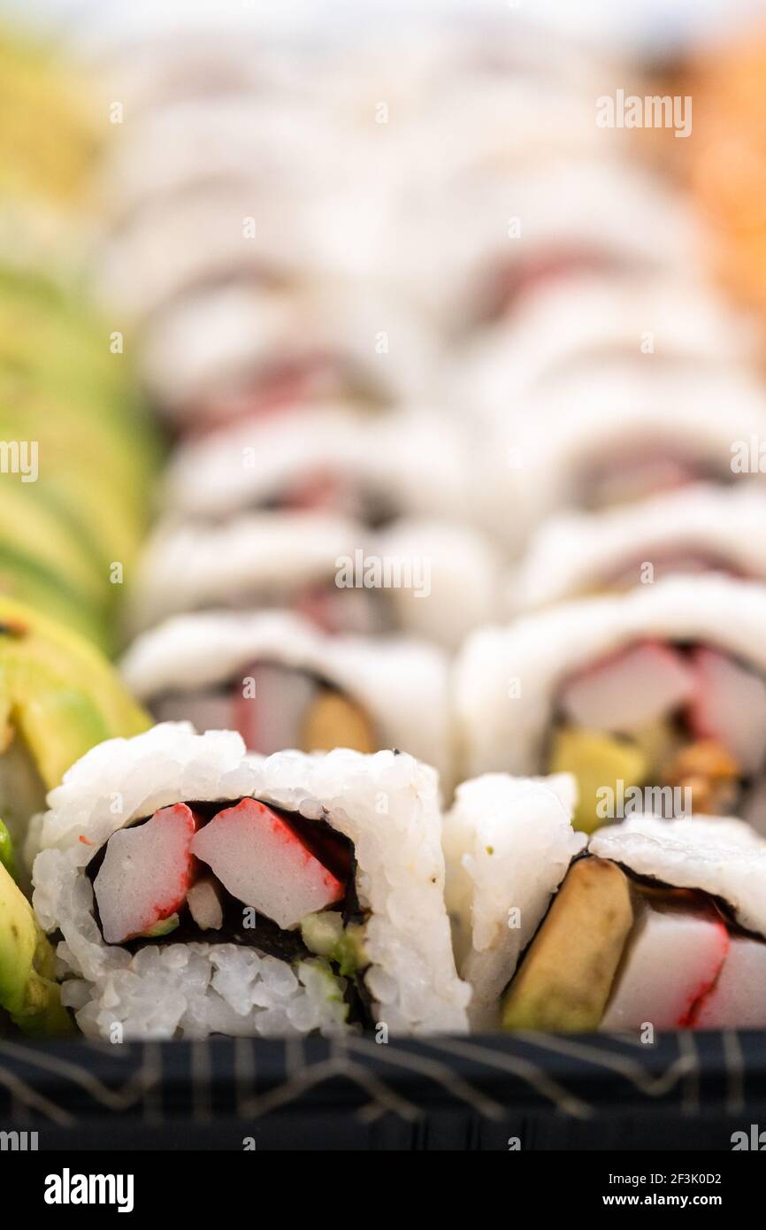 Pre-packaged variety of sushi and sushi rolls in a plastic tray Stock ...
