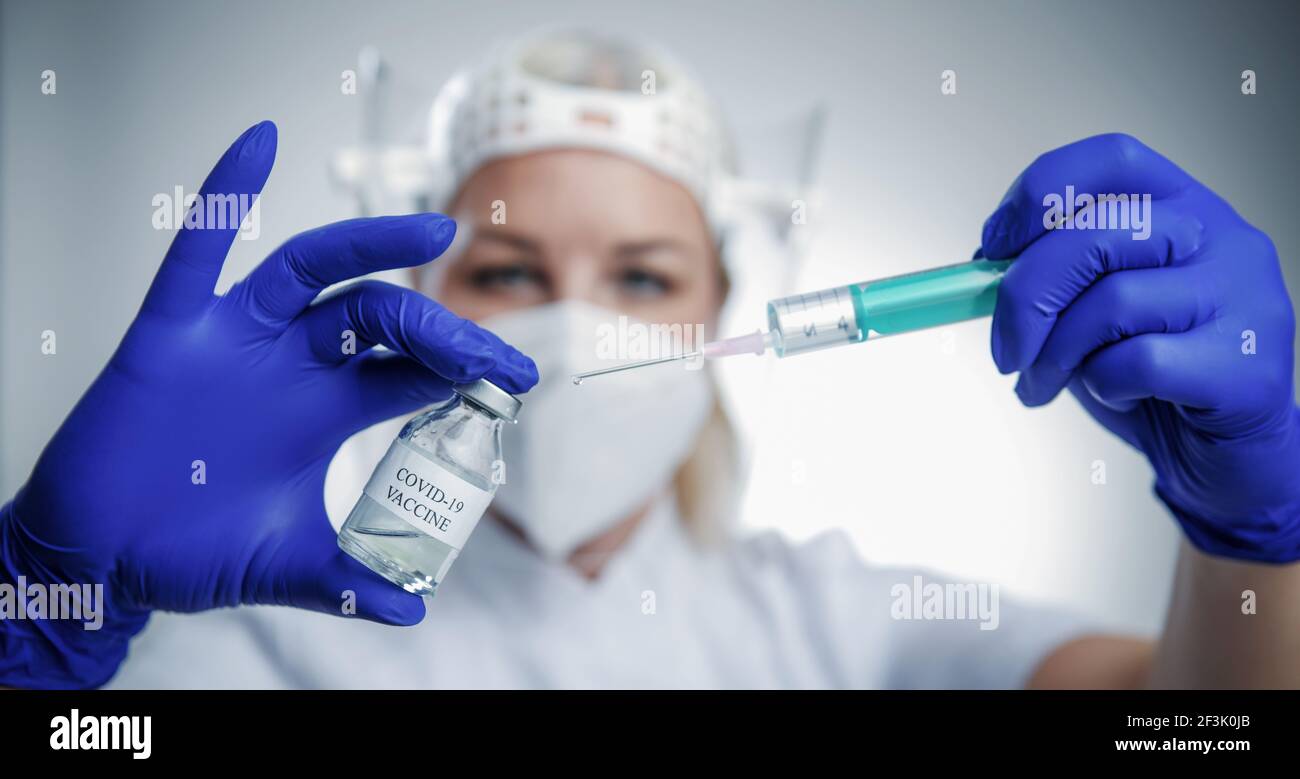 Detail closeup of syringe needle and ampoule , nurse taking injection ...