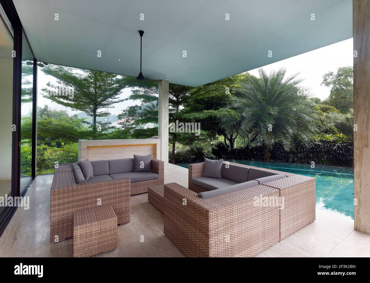 Outdoor seating on poolside terrace in Private Residence, Singapore ...