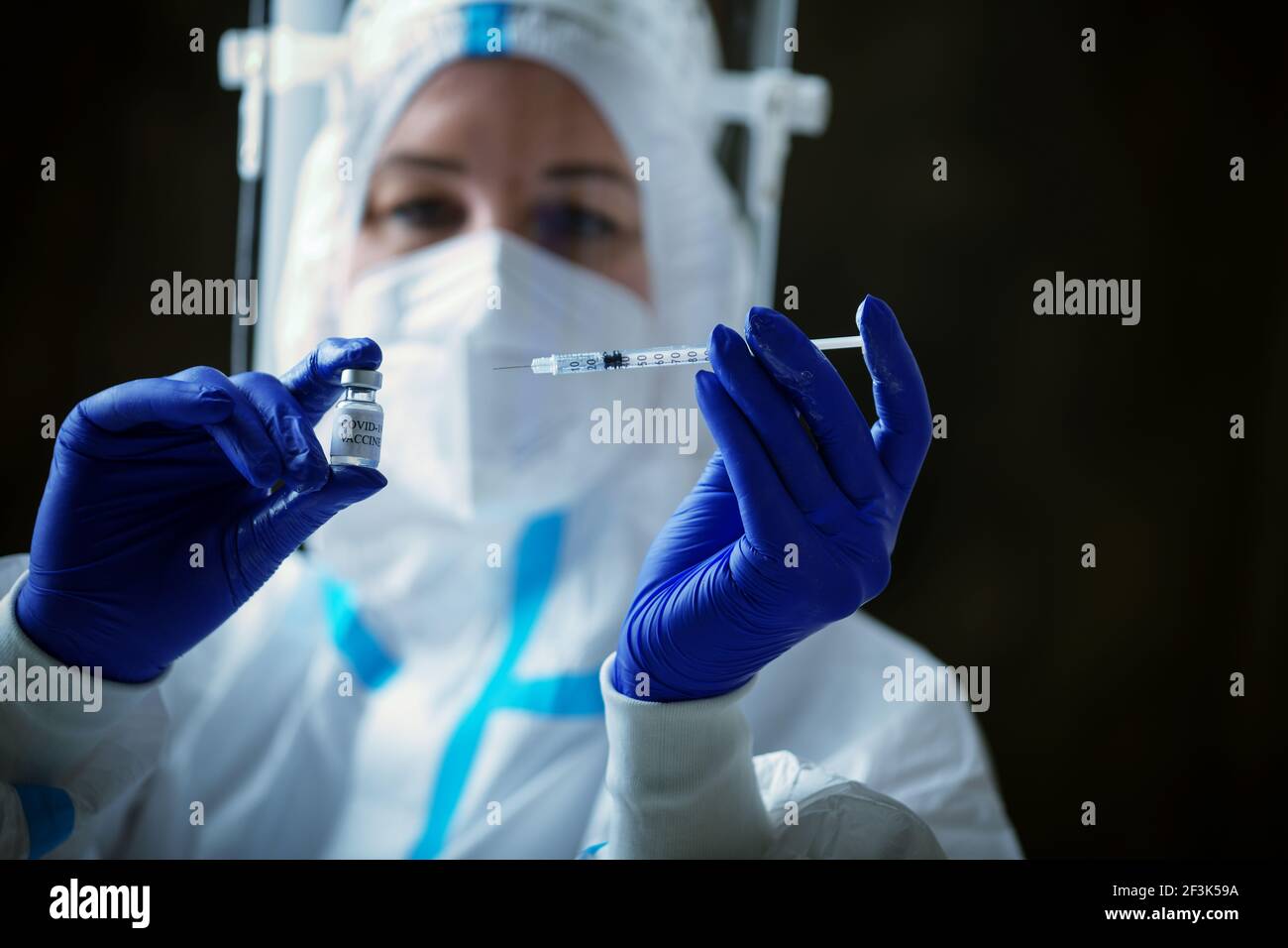 Detail closeup of syringe needle and ampoule , nurse taking injection ...