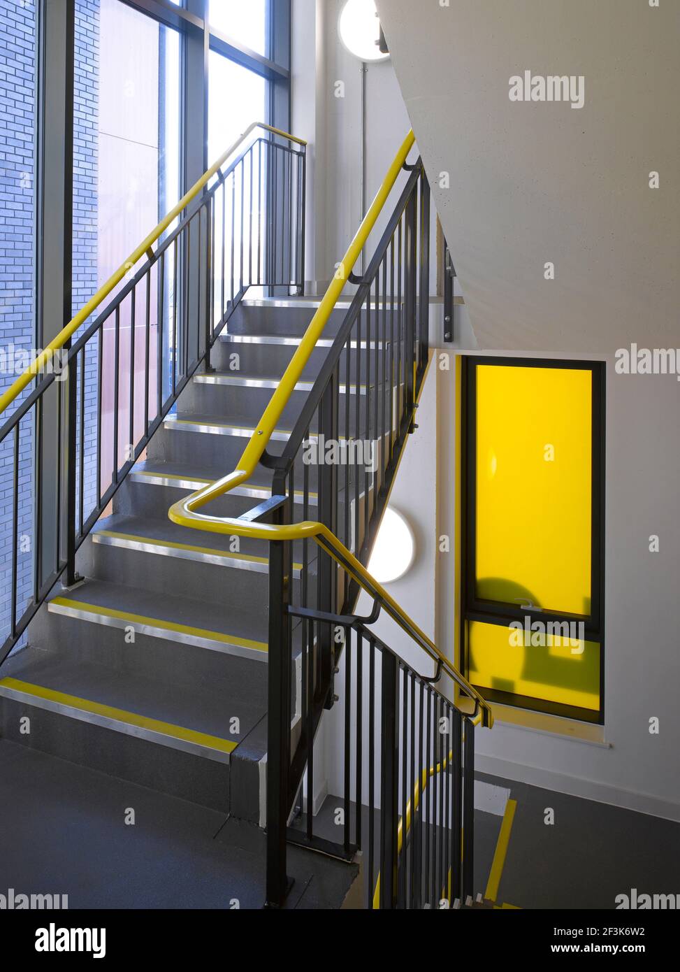 Yellow handrail in staircase at Sutton's Wharf North, Bow, London, UK ...