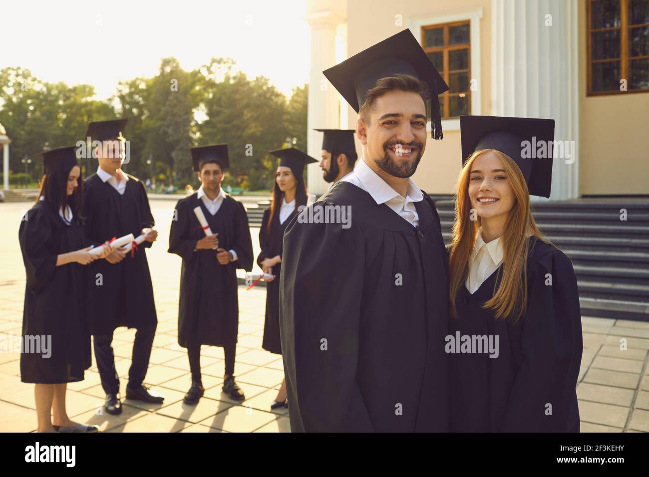 Young smiling couple boy and girl students university graduates ...